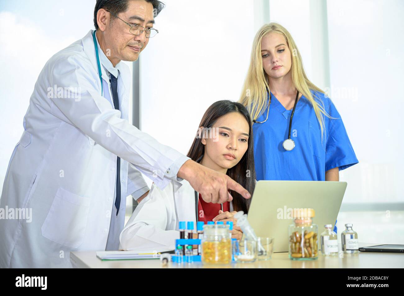 Group of doctors wearing formal white coat and blue scrubs suit ...