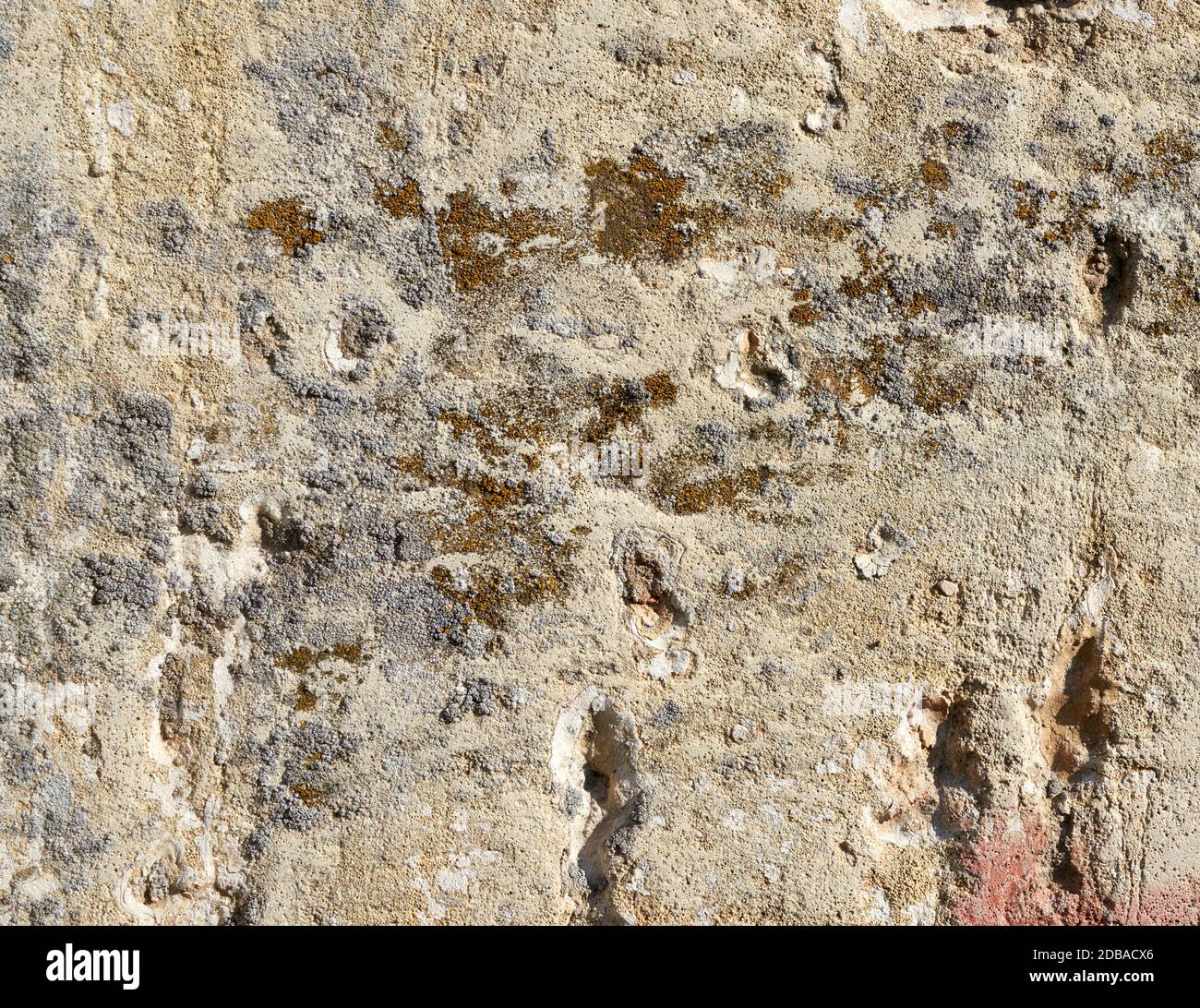 wall of yellow rectangular stones with cement, fragment of ancient ...