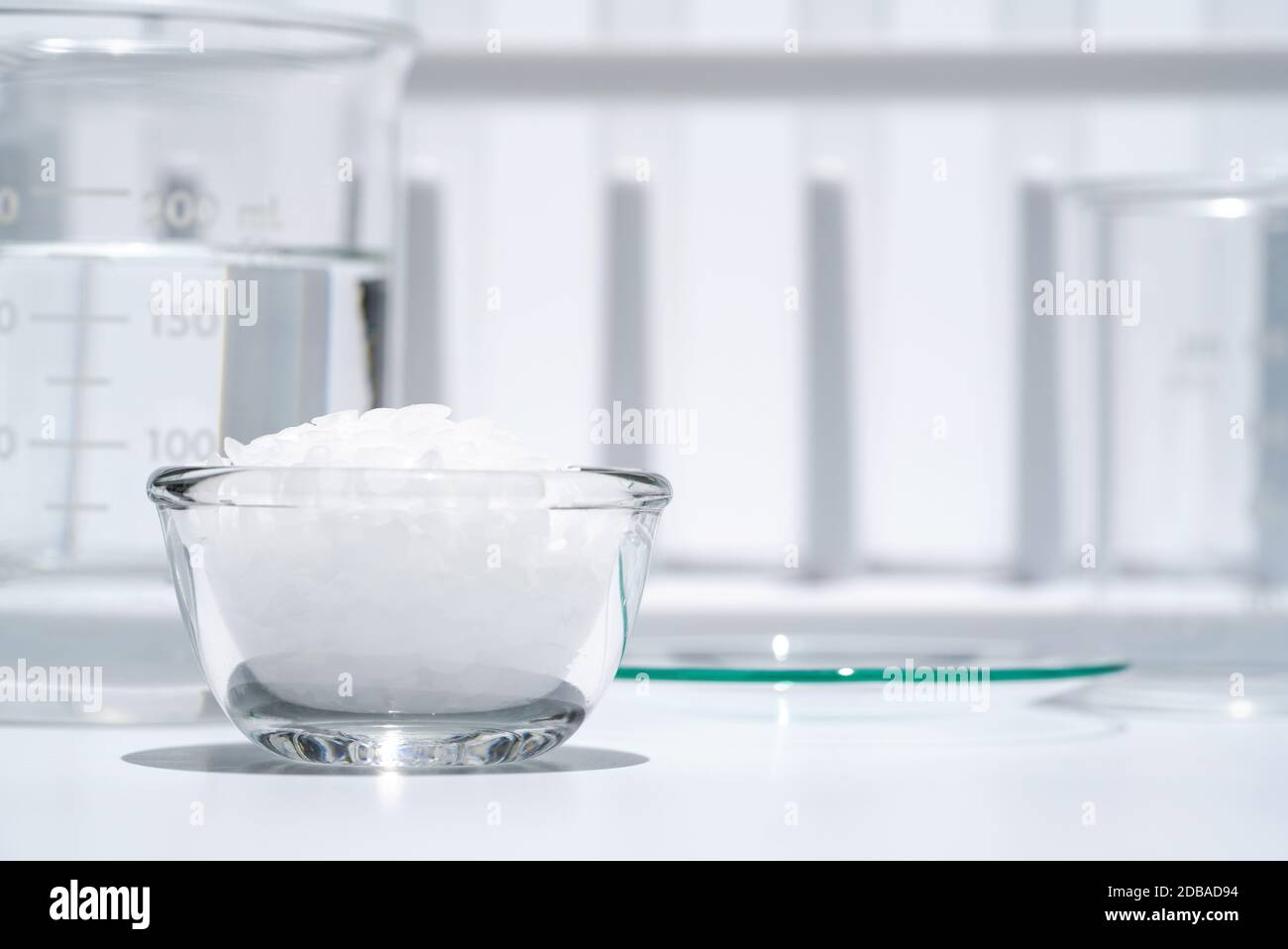 Close up White flake chemical on laboratory table. Cetyl esters wax ...