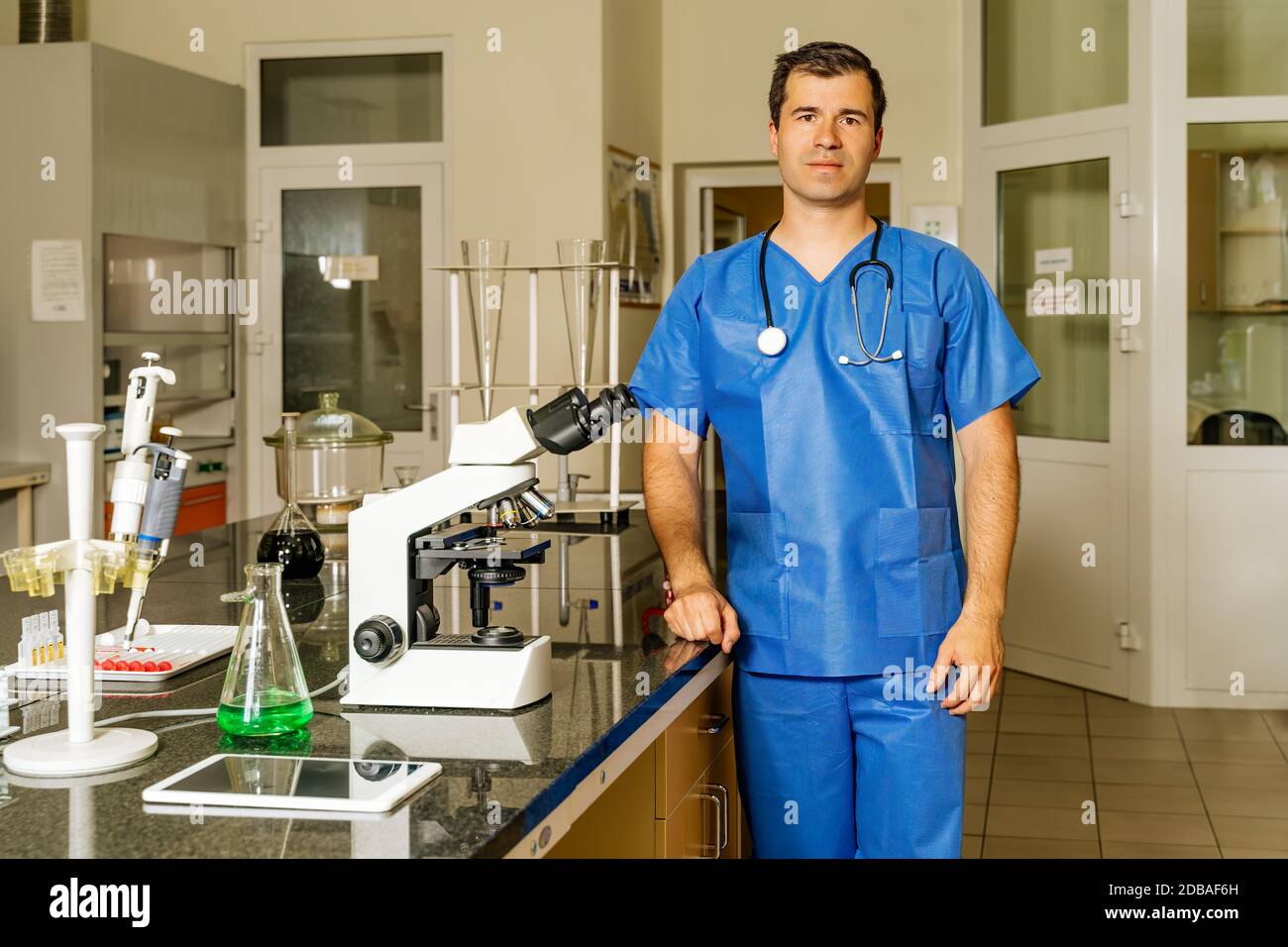 Male doctor or lab technician checking or researching covid 19 virus ...