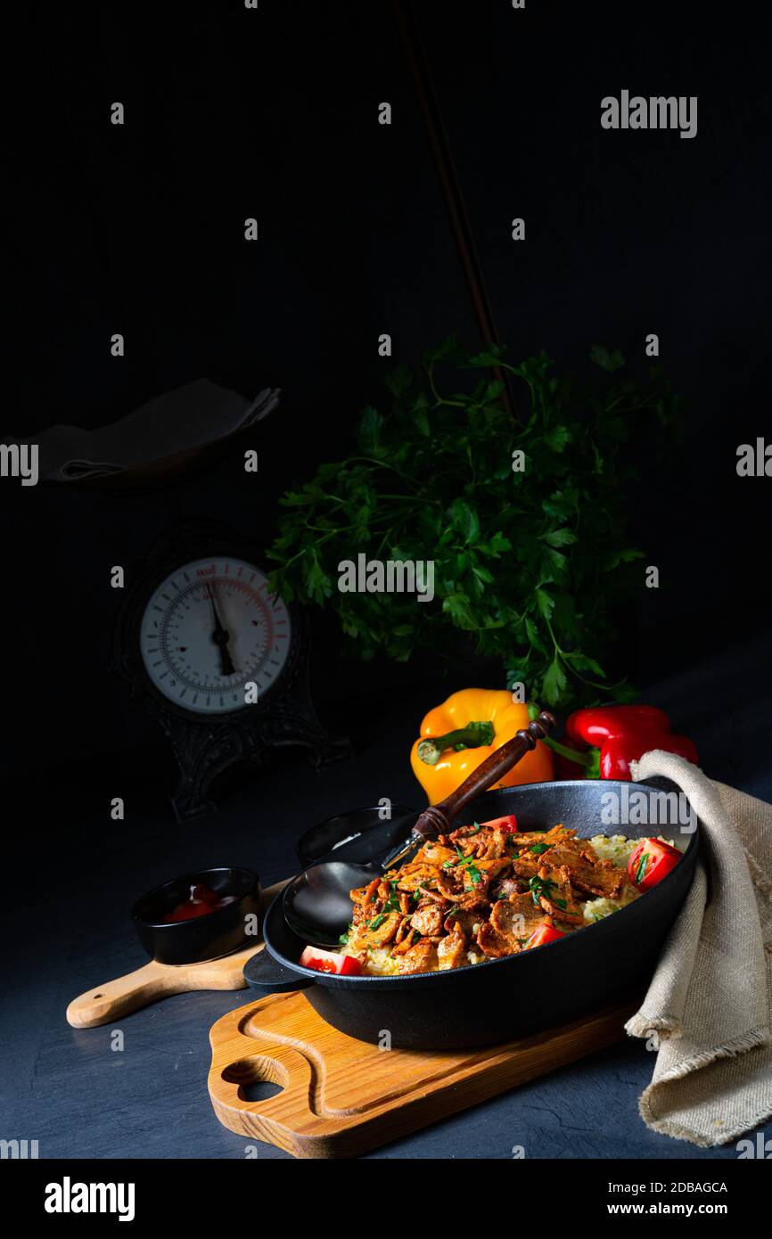 rustic bulgur pans with gratinated gyros and yoghurt Stock Photo - Alamy