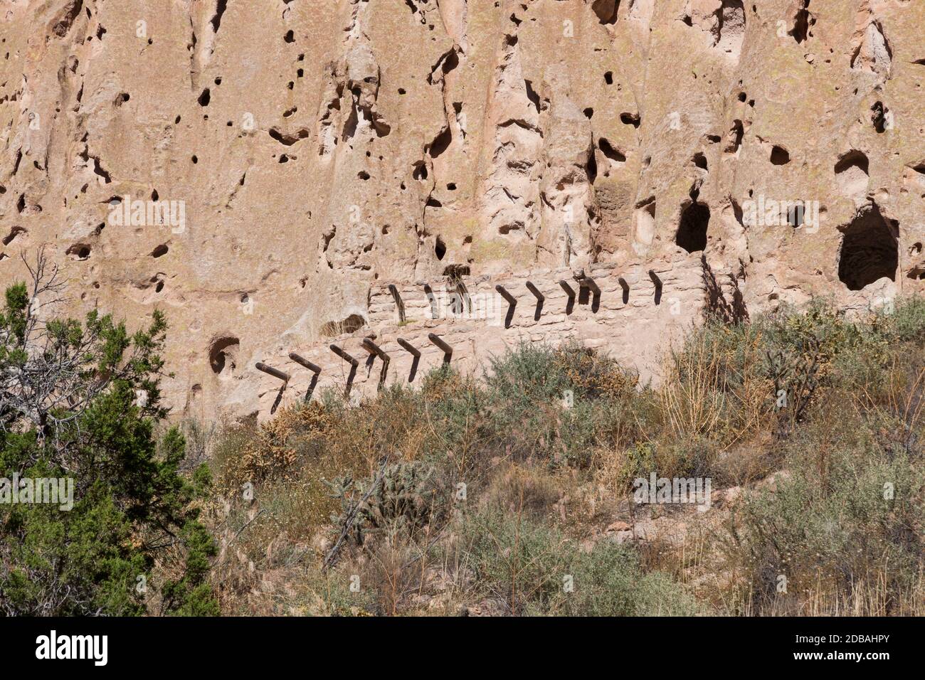 A building made of brick and clay with wooden poles to support a roof ...