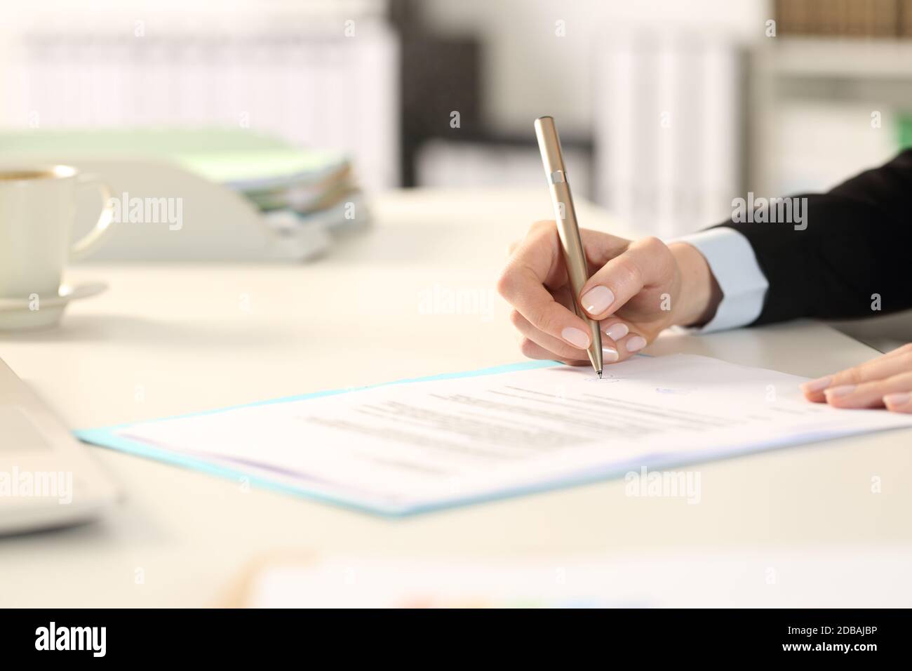 Close up of executive woman hand signing contract on a desk in the ...