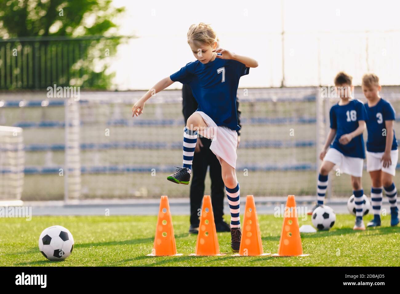 Boy jumping over football hi-res stock photography and images - Alamy