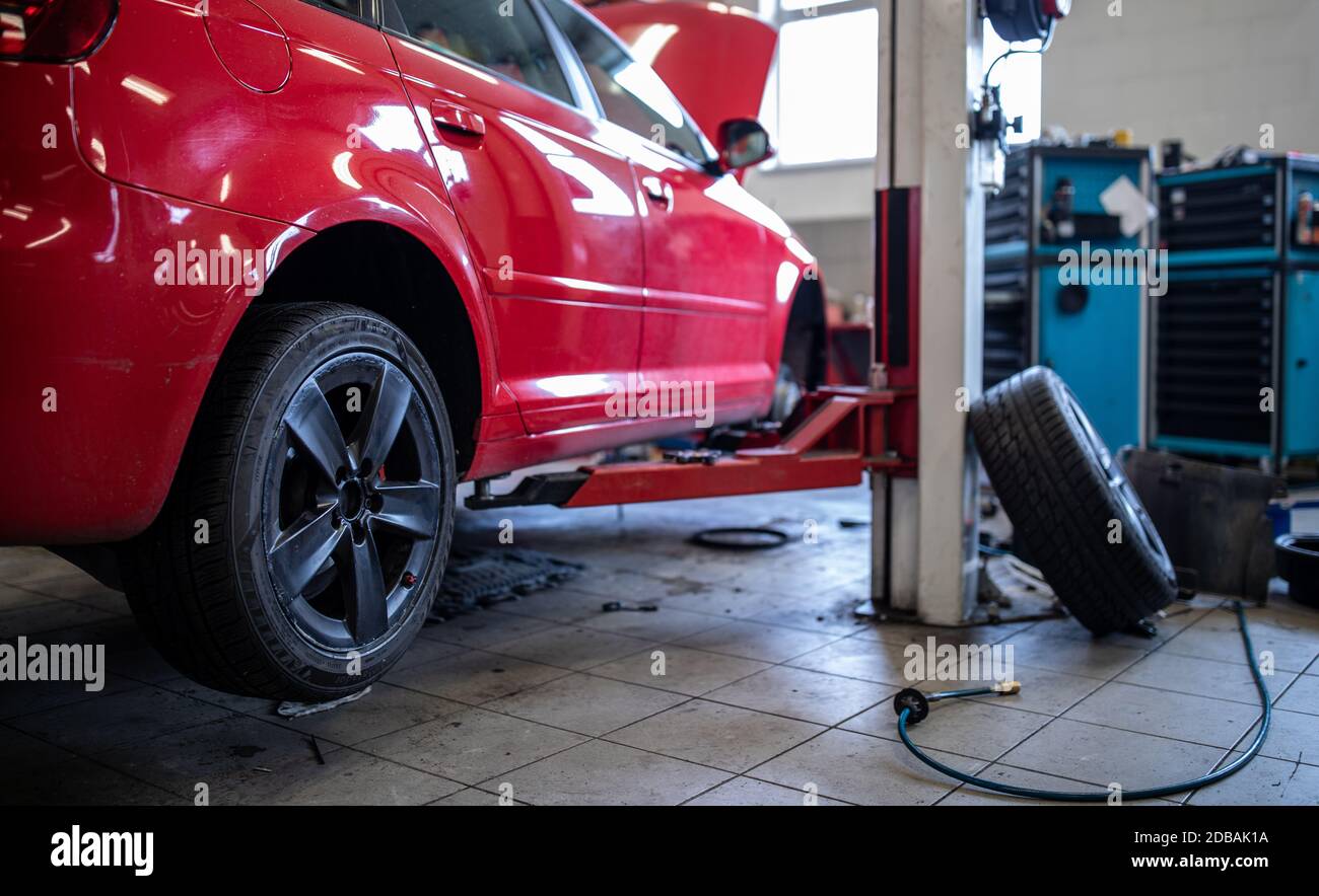 Car in a garage waiting to be serviced by a mechanic (color toned image ...