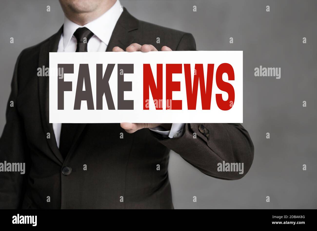 Fake News label is held by businessman Stock Photo - Alamy