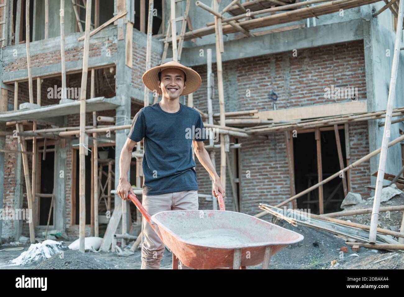 Pushing wheelbarrow builder hi-res stock photography and images - Alamy