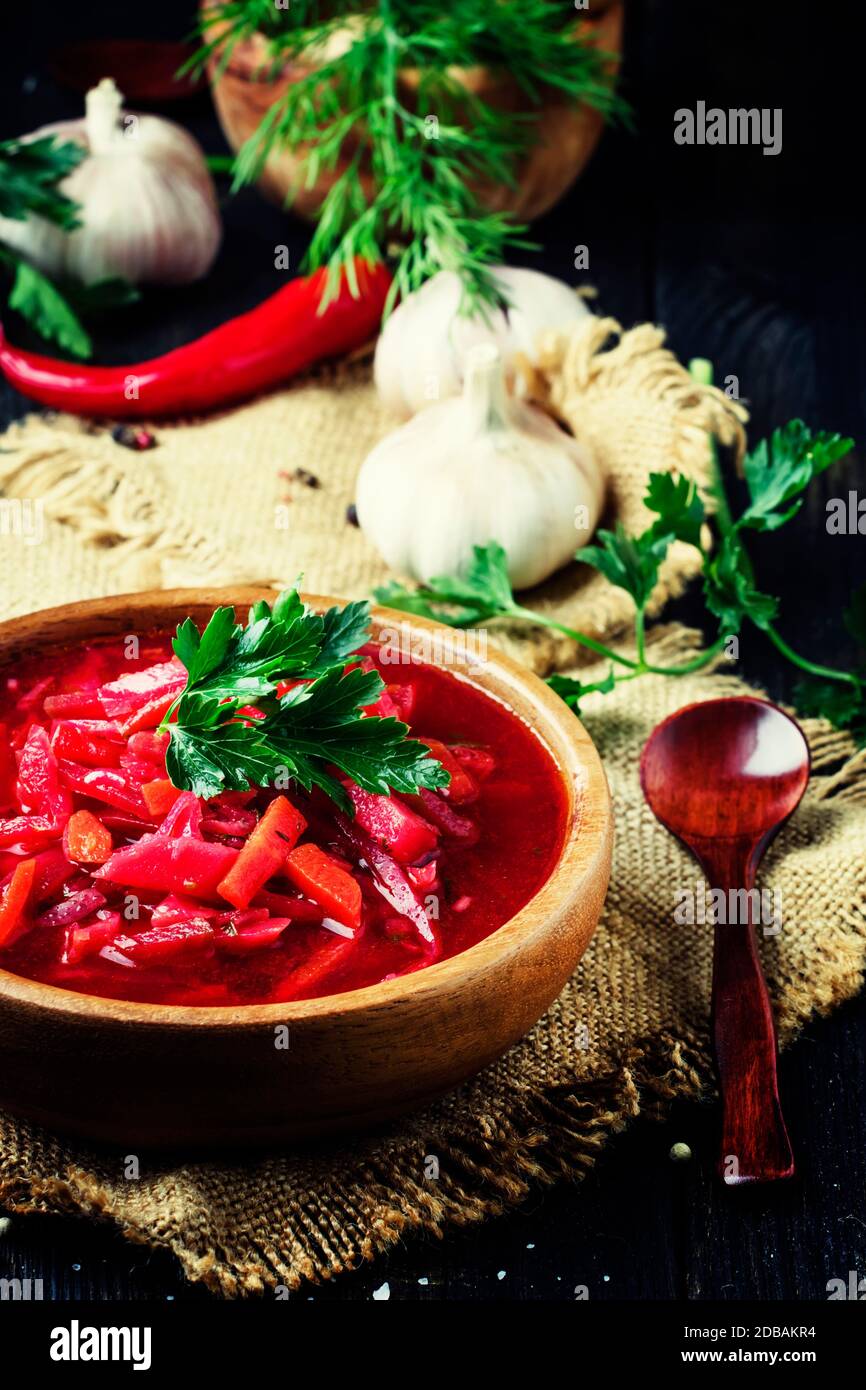 Borsch soup with beets, cabbage and meat in a wooden bowl, rustic style ...