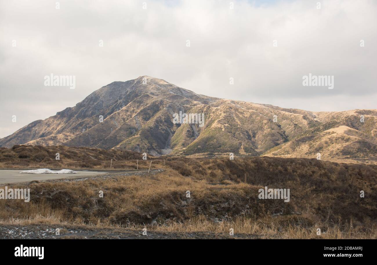 Mount Aso and Kusasenri in winter. covered by golden yellow grassland - Kumamoto, Japan Stock ...