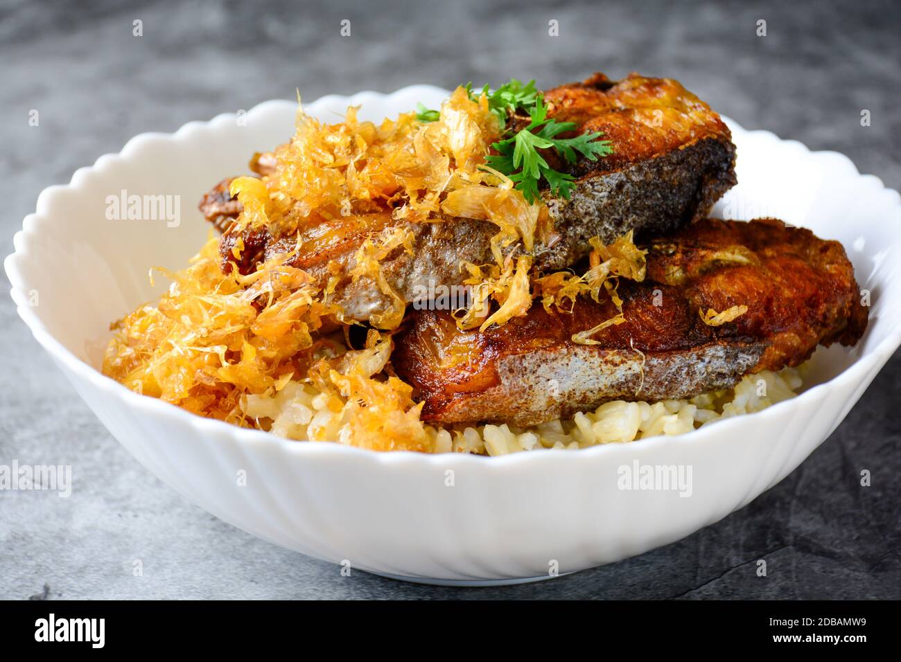 Deep fried sliced Pangasius fish with garlic, served with brown rice ...