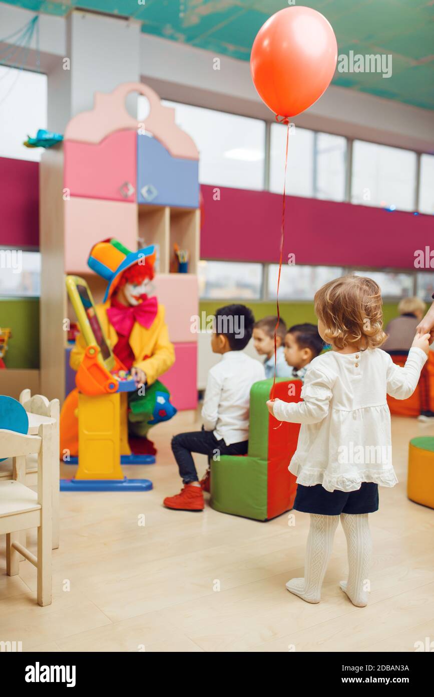 Funny clown with happy children play in the alphabet on board. Birthday ...