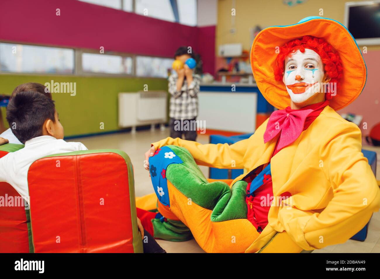 Funny clown animator and group of little boys. Birthday celebrating in ...