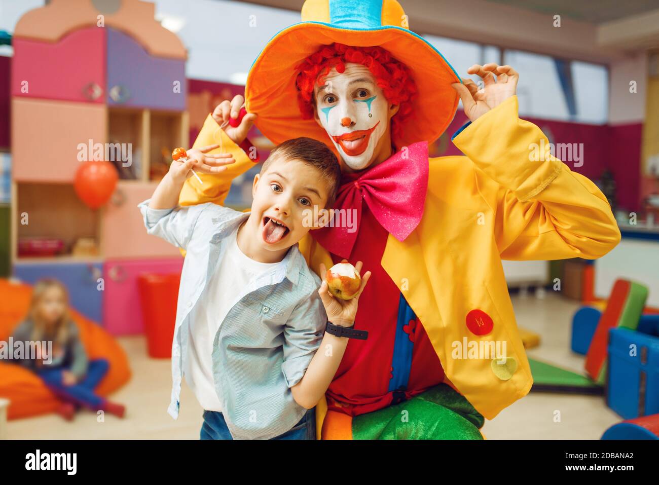 Funny clown, entertainment show with little boys in kindergarten ...