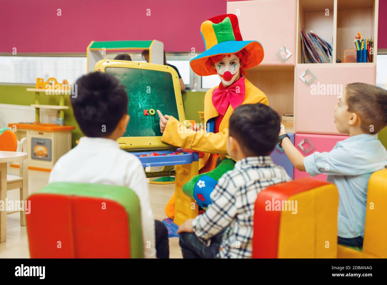 Funny clown with happy children play in the alphabet on board. Birthday ...
