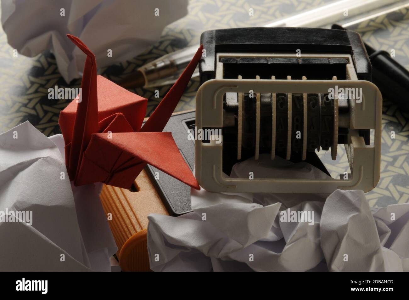 Rubber stamp on waste paper and origami Stock Photo - Alamy