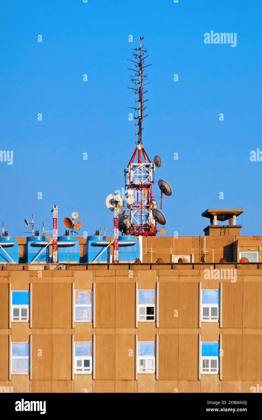 Communication tower building with antenna on top Stock Photo - Alamy