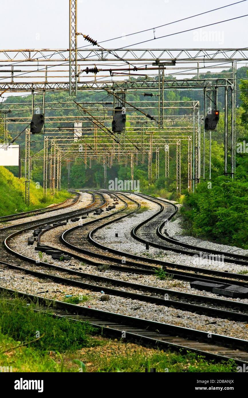 Four lane railroad with double curve tracks Stock Photo - Alamy