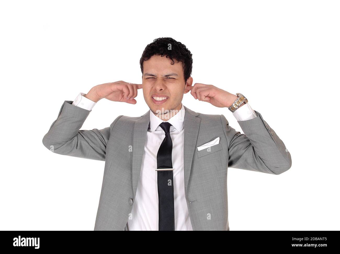 A handsome young man in a gray suit standing with his fingers in his ...