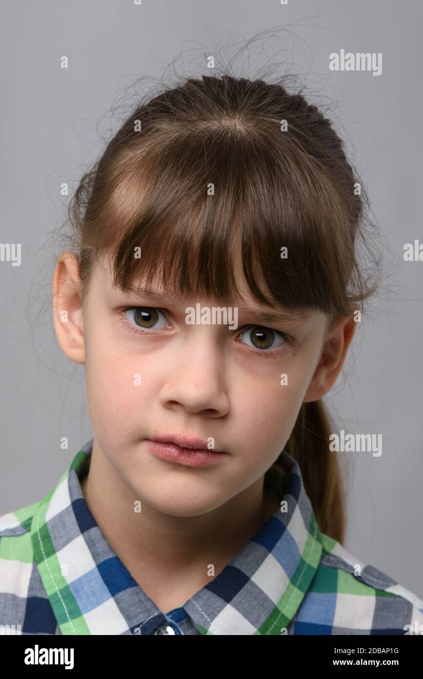 Portrait of a perplexed ten-year-old girl of European appearance, close ...