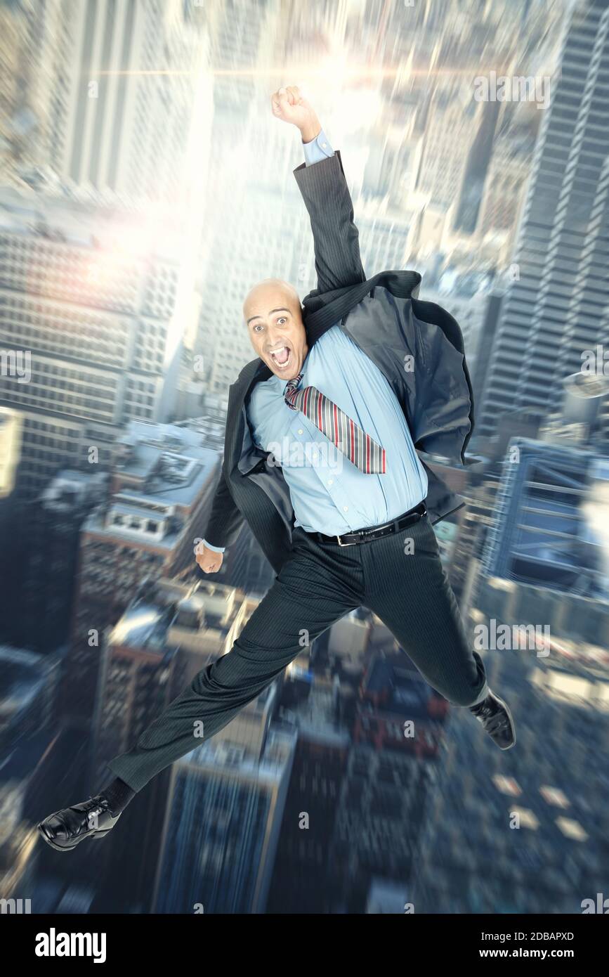 Businessman jumping high with big buildings as background Stock Photo ...