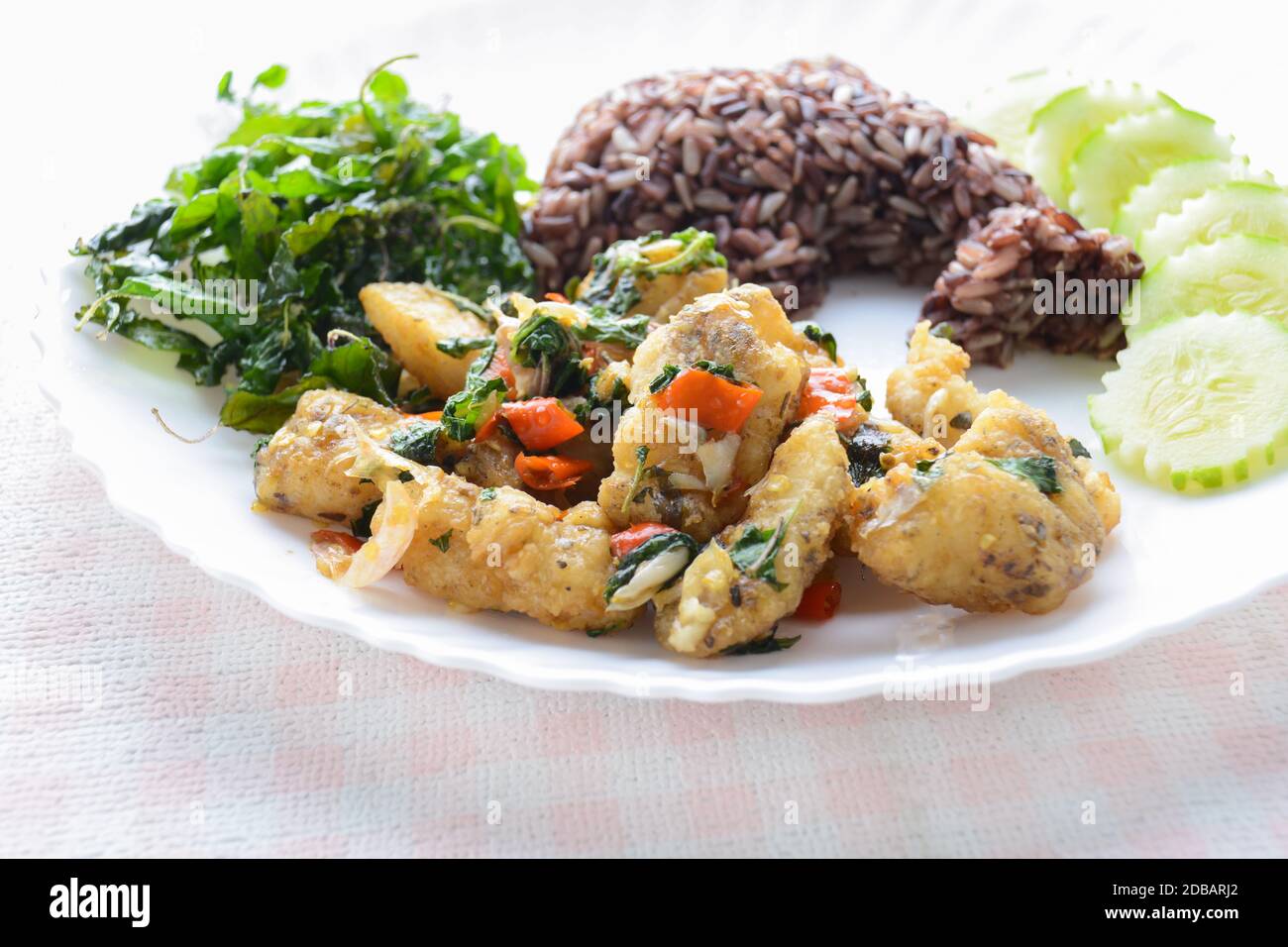 Stir fried fish with chili and basil, served with steamed rice and ...