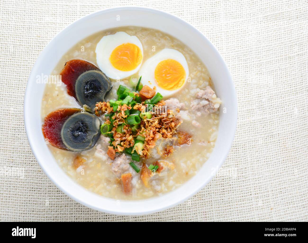 Congee, Rice porridge with minced pork, boiled egg and century egg ...