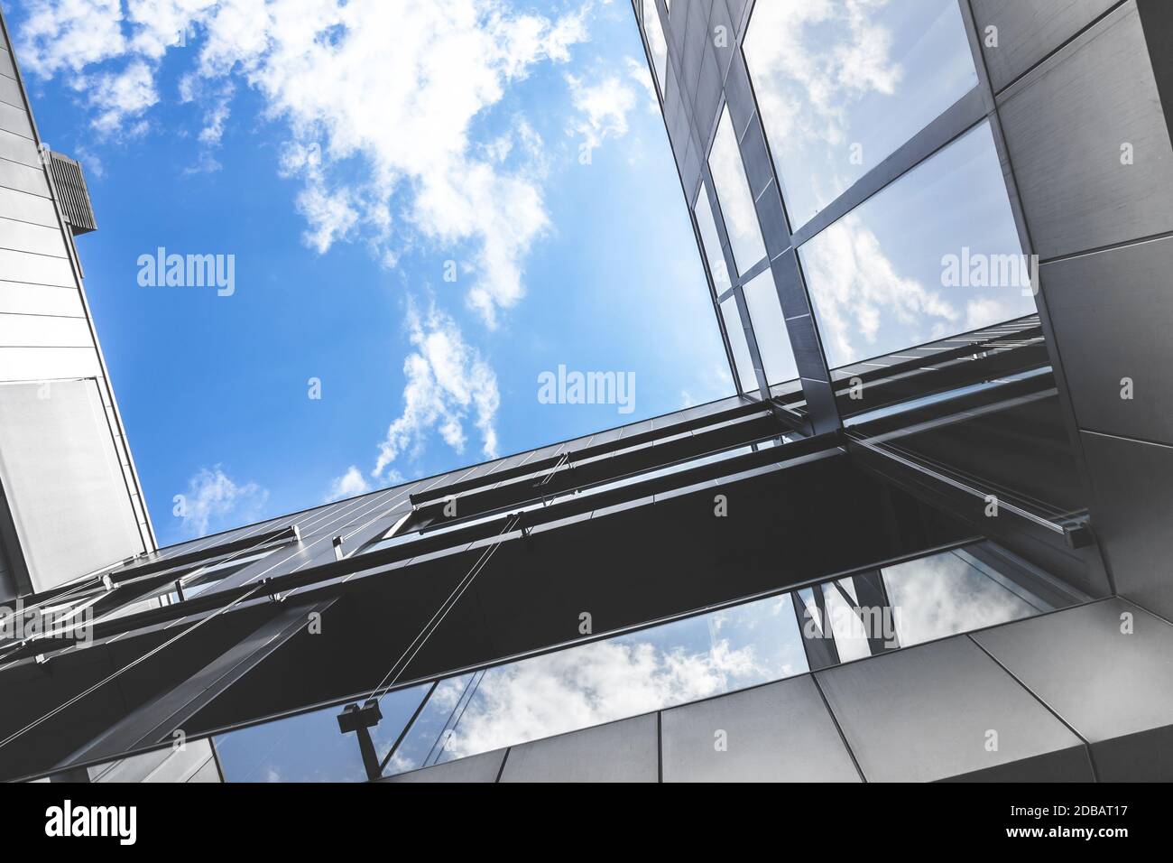 Bottom view of modern office building with amazing sky. Economy restart ...