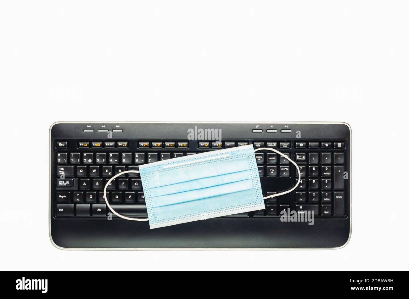 computer keyboard with a medical mask on it. Top view with space for ...