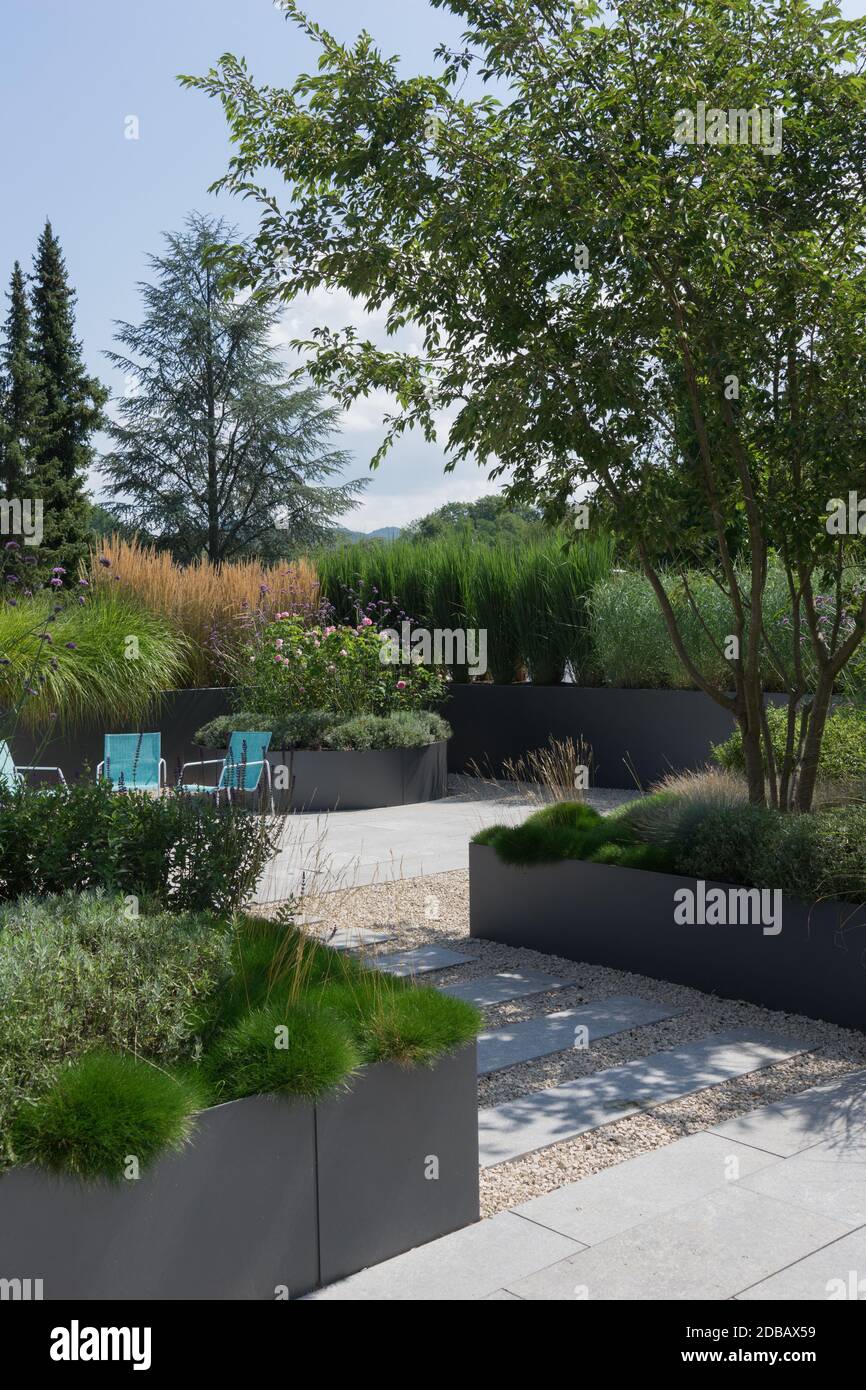 Modern garden architecture with herbs and grass Stock Photo - Alamy