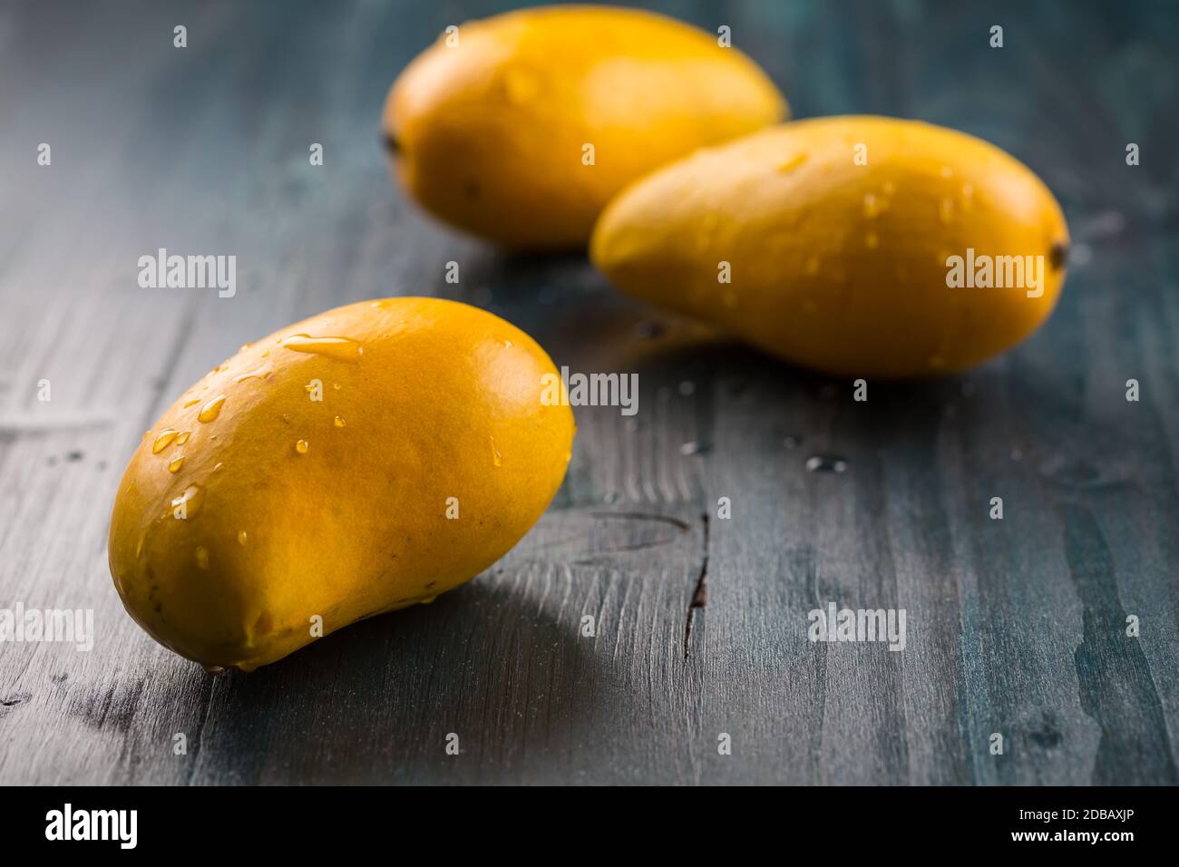 Fresh honey mango fruits on wooden background. Ataulfo (mango) from ...