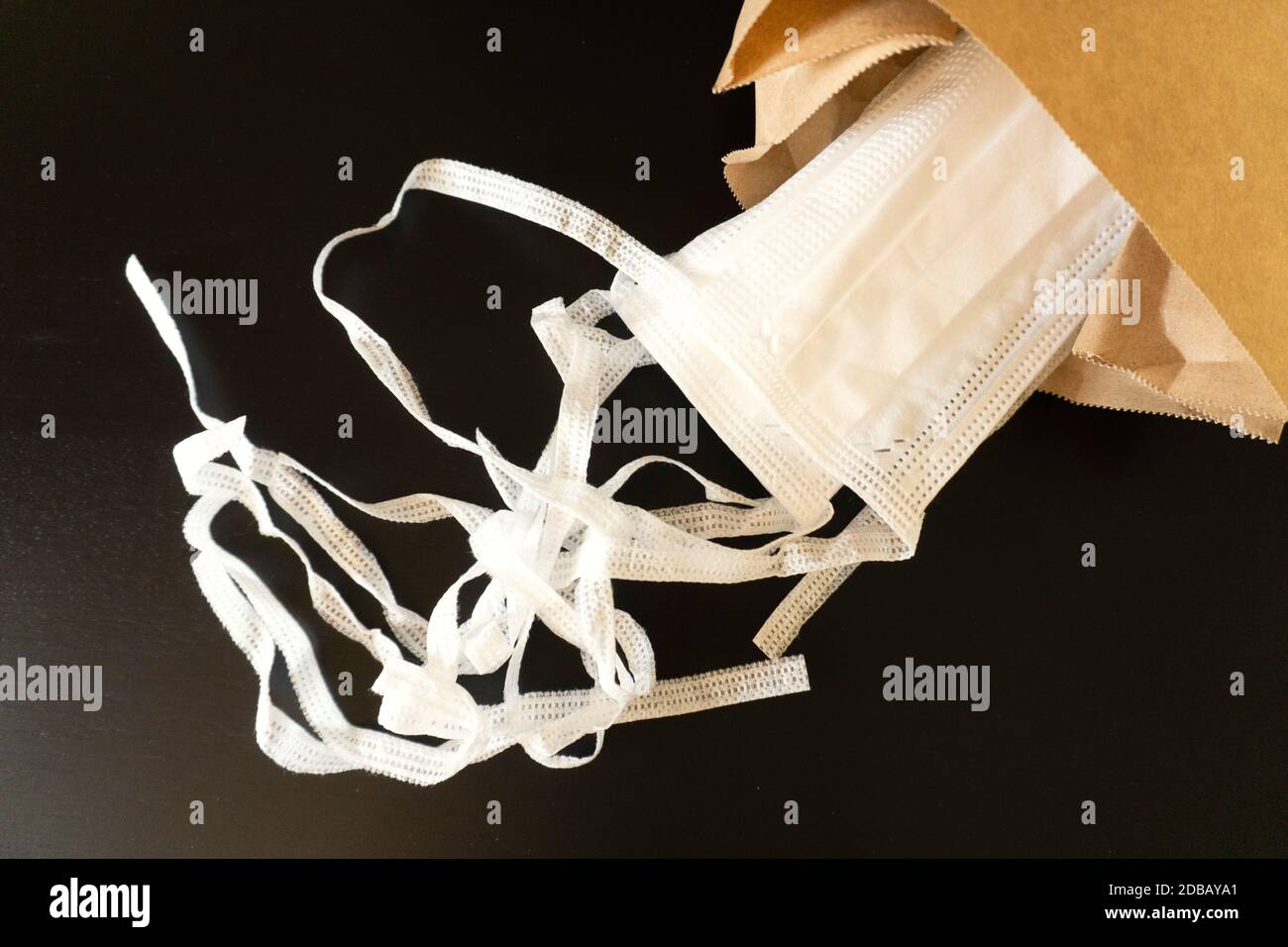 Five new white protective medical masks on the ties lie in a craft ...