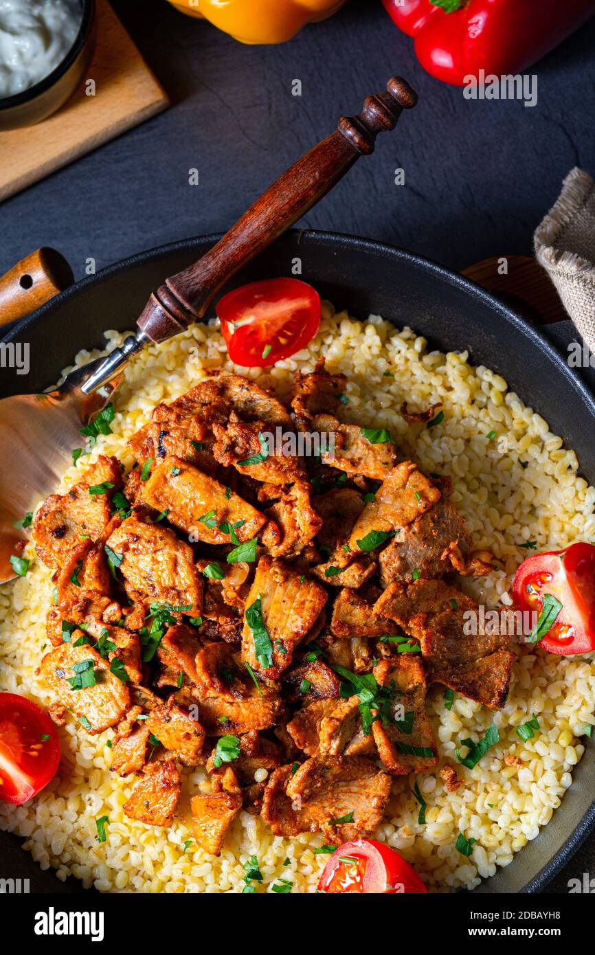 rustic bulgur pans with gratinated gyros and yoghurt Stock Photo - Alamy
