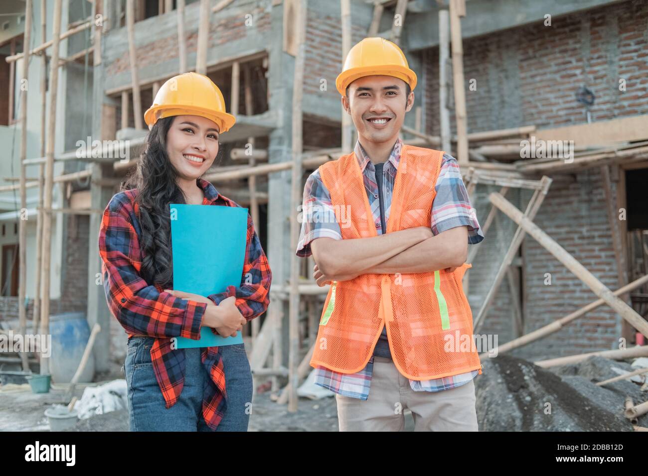 Asian construction workers smiling men and women at the camera wearing ...