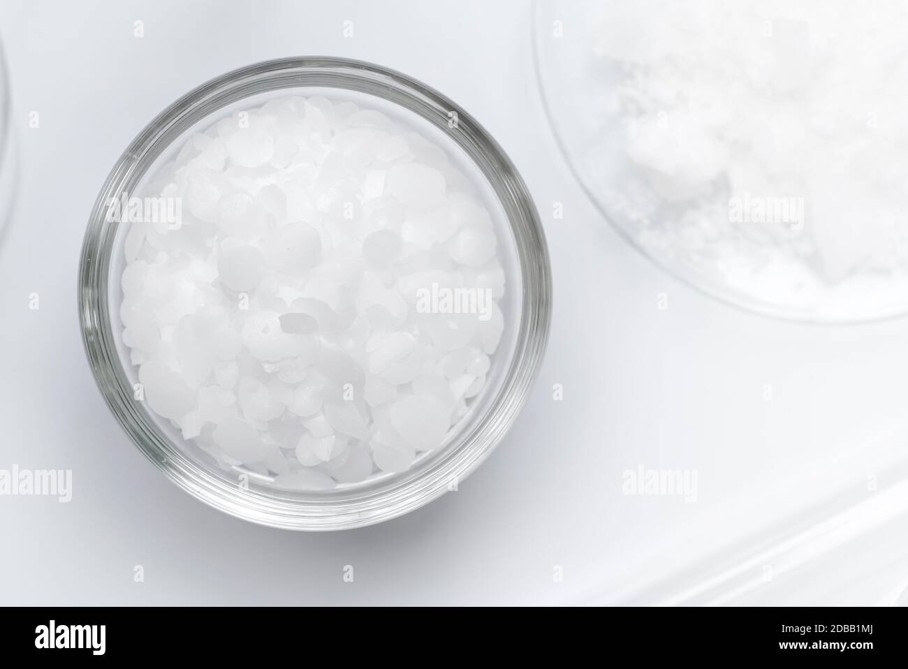 Close up White flake chemical on laboratory table. Cetyl esters wax ...