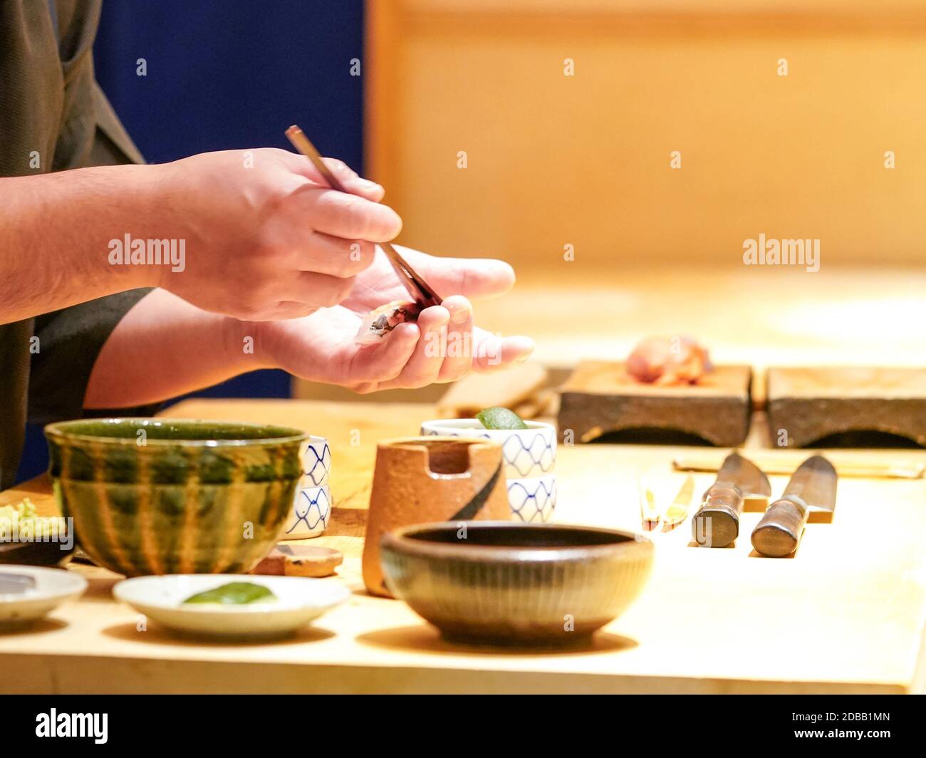 The chef is brushing shoyu sauce onto the raw fish. Enjoy Omakase ...