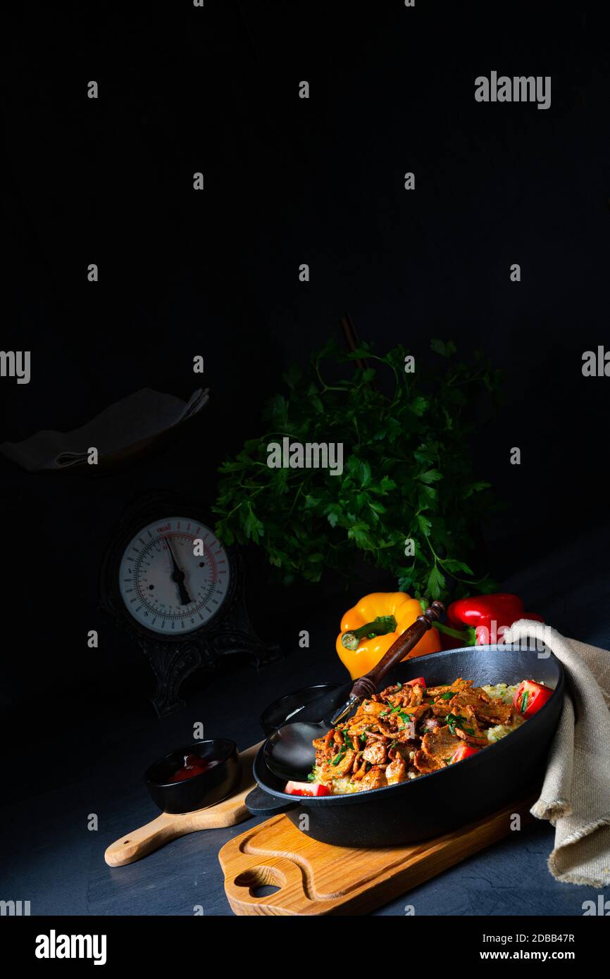 rustic bulgur pans with gratinated gyros and yoghurt Stock Photo - Alamy