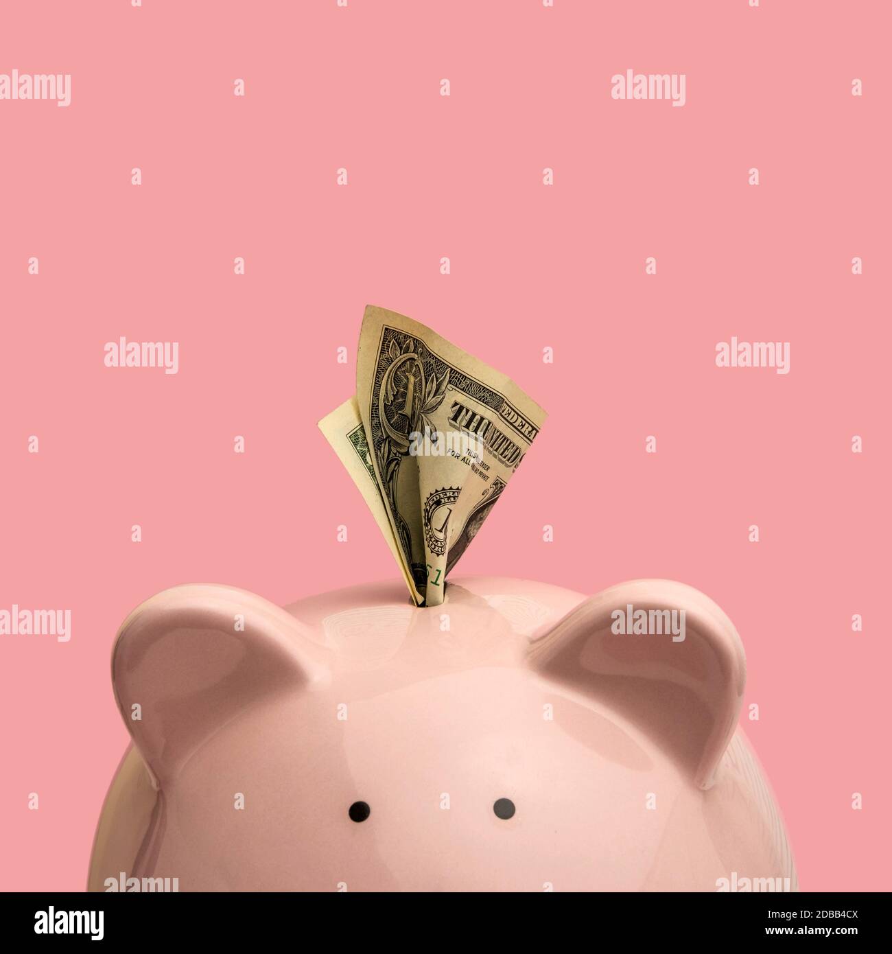 Piggy bank with US dollar bill on pink background Stock Photo - Alamy