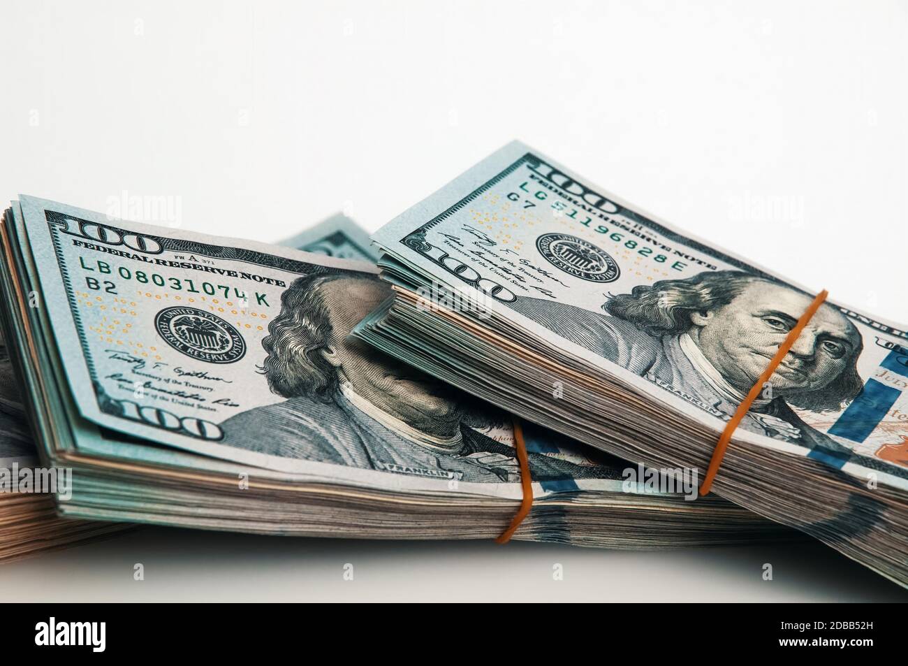 Isolated bundle of dollars. A large stack of hundred-dollar bills lies ...