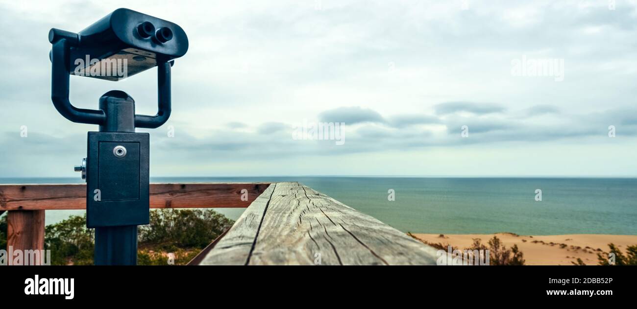 Binoculars for the observation deck on the beach at the wooden railing ...