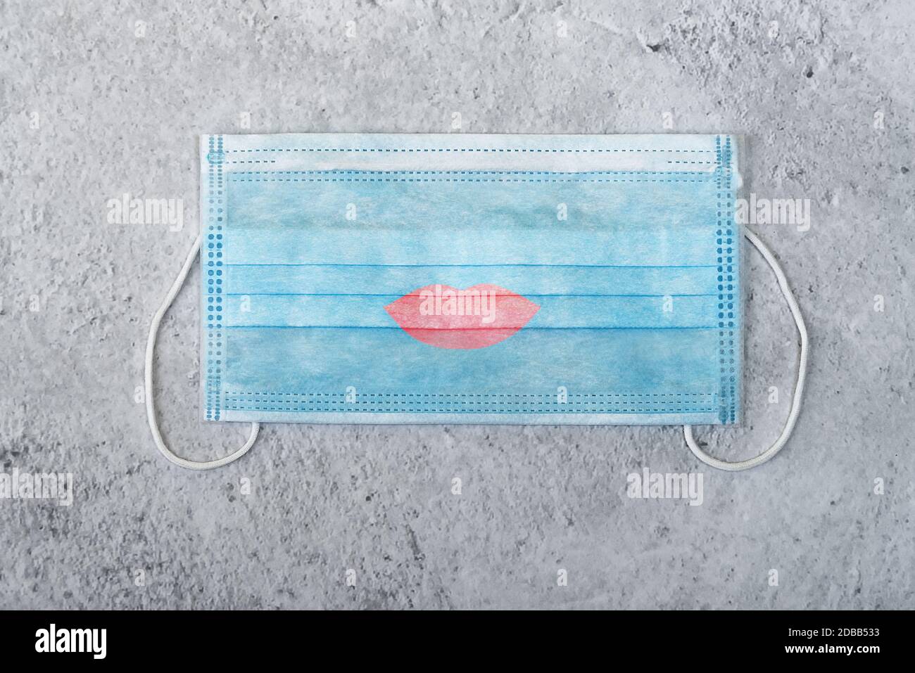 A medical mask with a drawn lips, kiss. A typical surgical mask to ...
