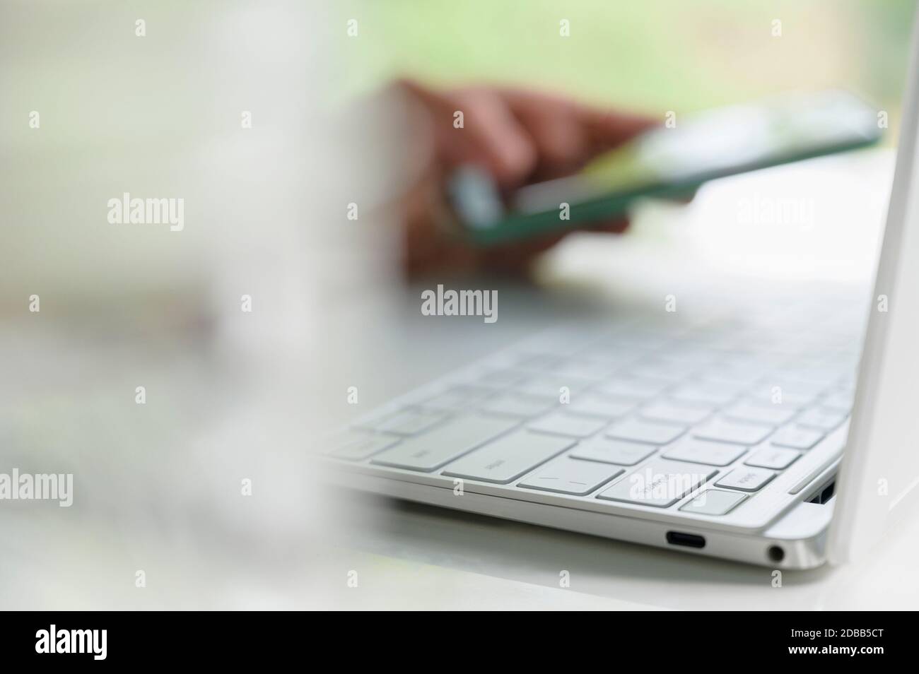 Hands laptop phone hi-res stock photography and images - Alamy