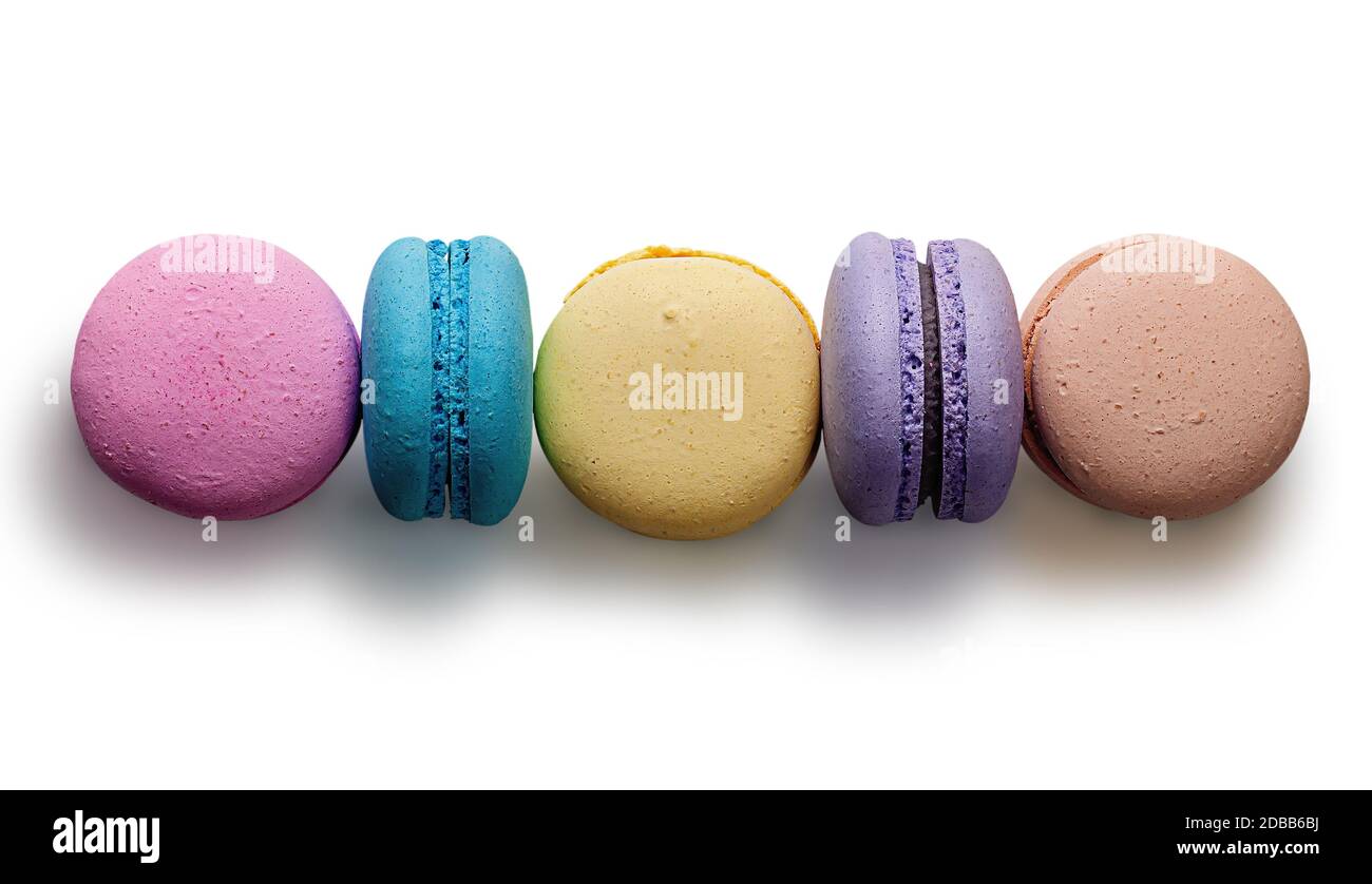 Five multicolored macaroon in row on white background Stock Photo - Alamy