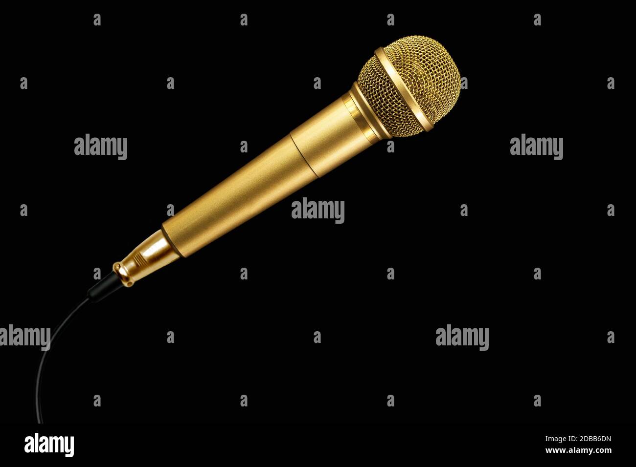 Golden microphone with cable on black background Stock Photo - Alamy