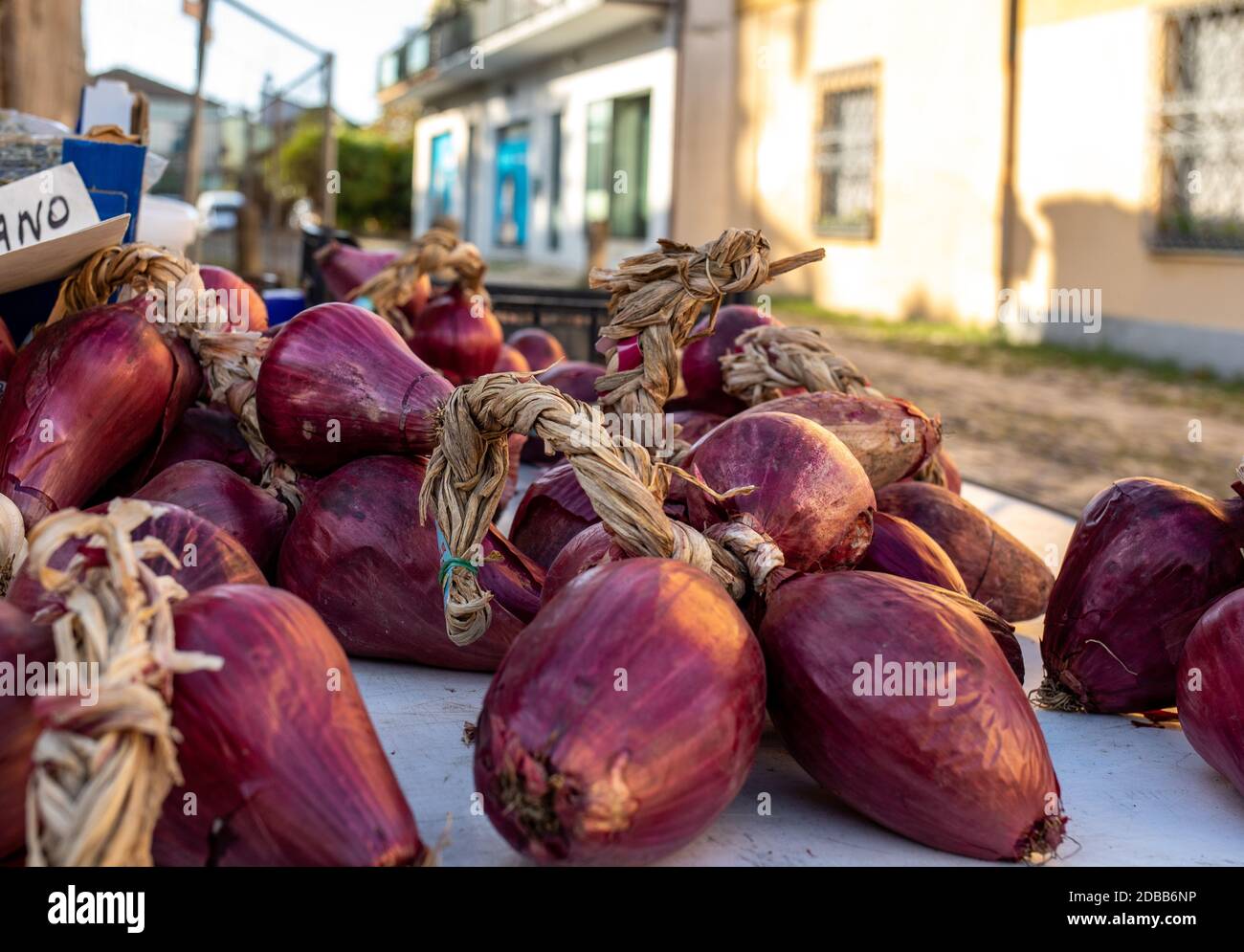 Red onions from Tropea (cipolla rossa di Tropea) at a farmers market in ...