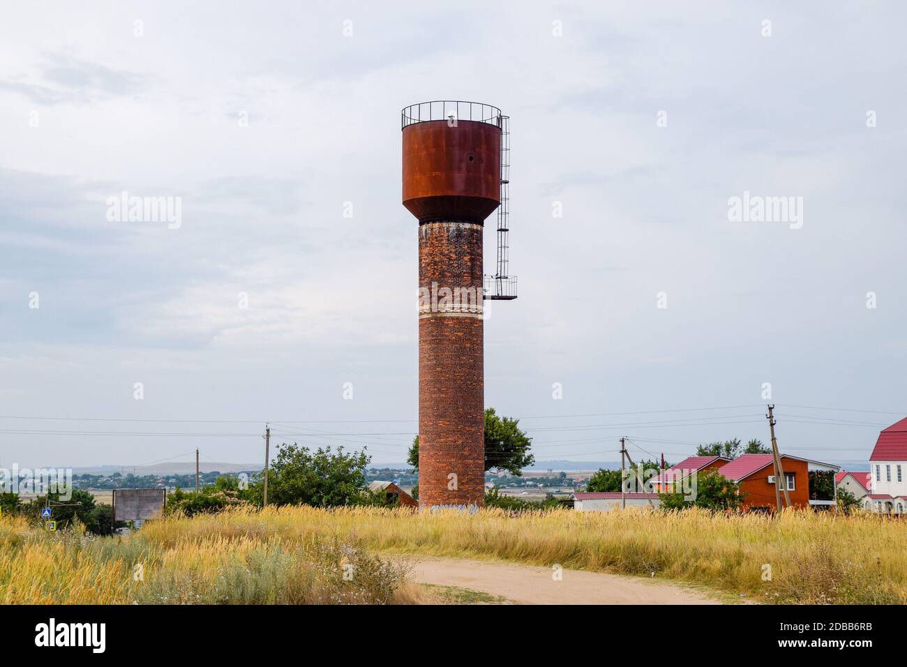 Rusty water tower against the sky. Old water pump Stock Photo - Alamy