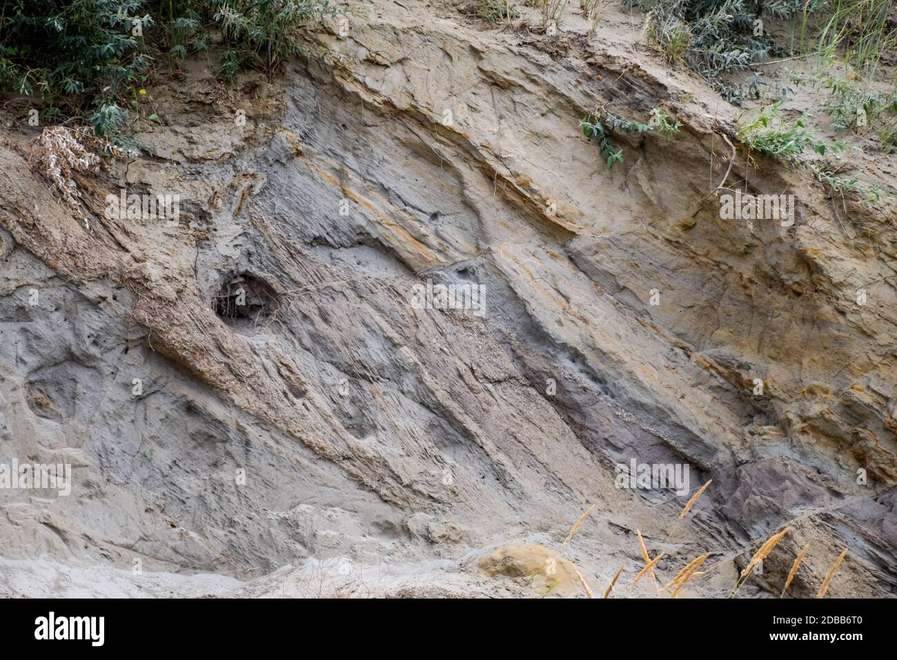 The sedimentary layers of the rock in the sand scree. sand, pebbles and ...