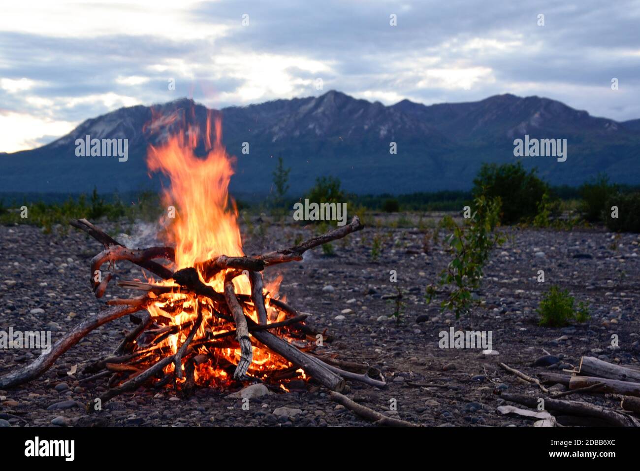 Campfire in Alaska mountains Stock Photo - Alamy