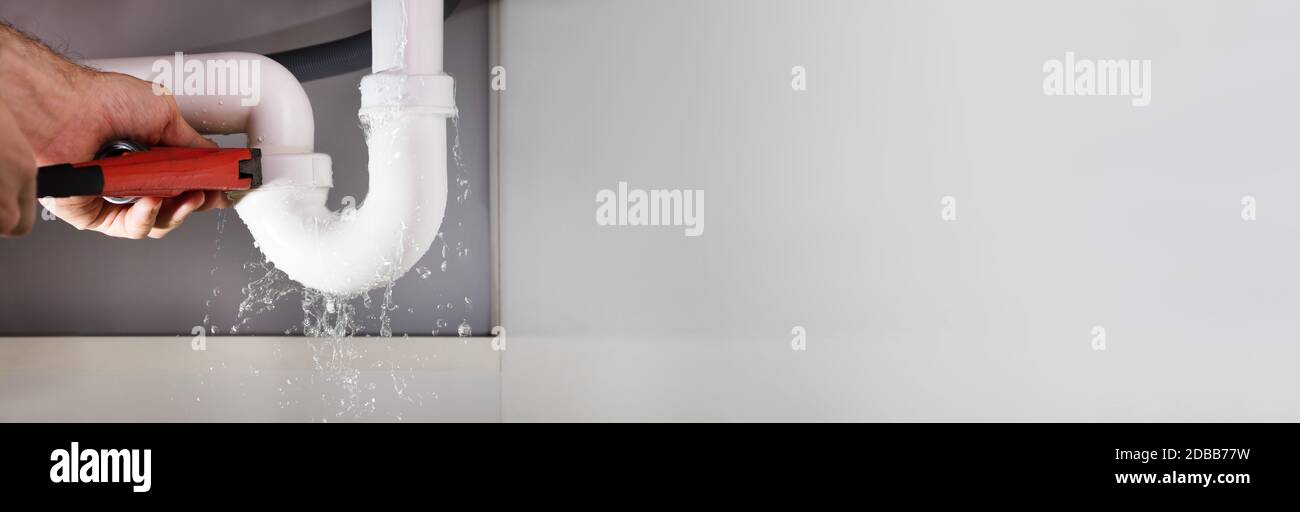 Pipe Water Leak Fix Service By Plumber Stock Photo - Alamy