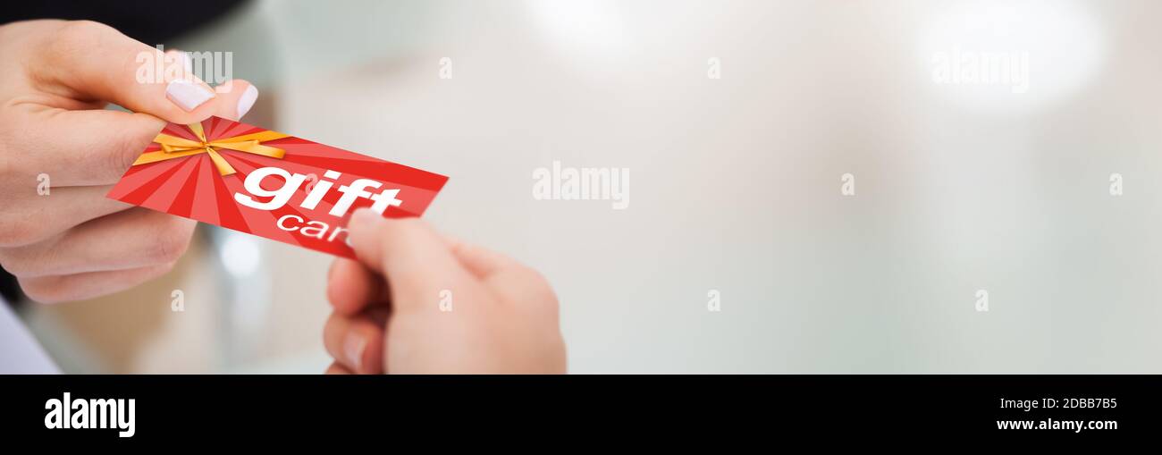 Person Giving Gift Card Voucher Present To Another Person Stock Photo ...