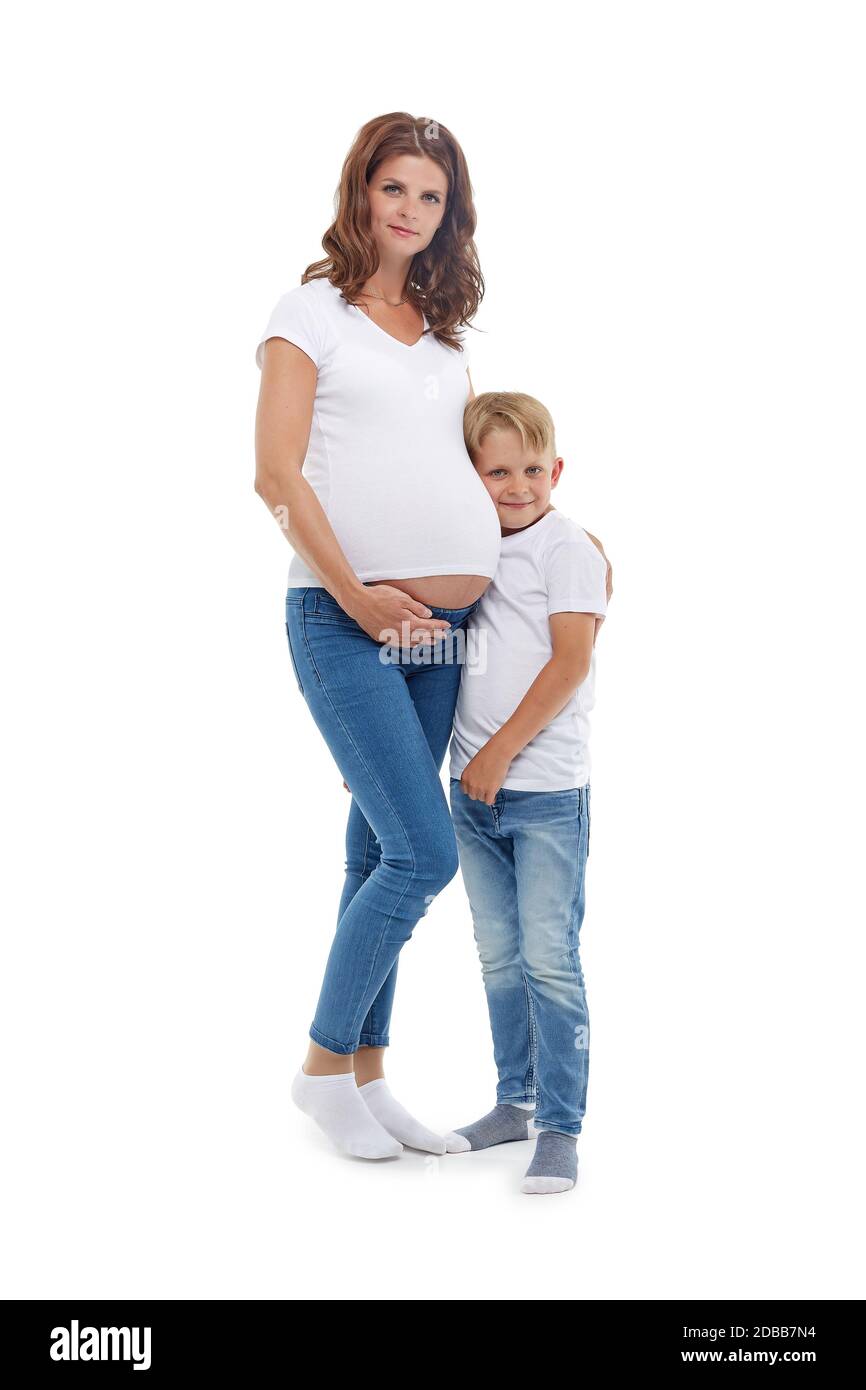 Friendly family. Little son and pregnant mother are embracing ...